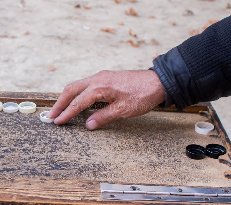 Two Men Gamble in the Street Playing Backgammon in the Fall Stock Image ...