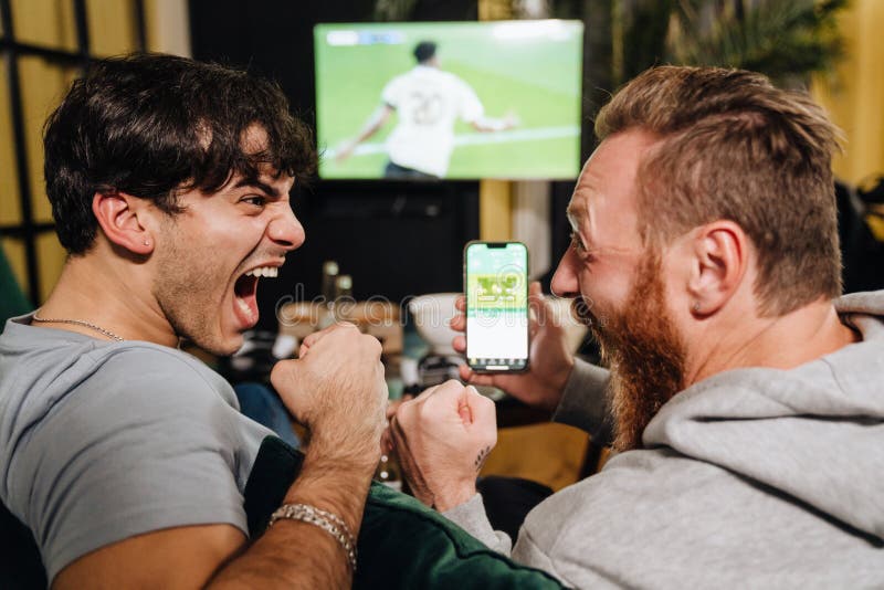 Two Men Gesturing As Winners while Making Bets at Bookmaker S Website ...