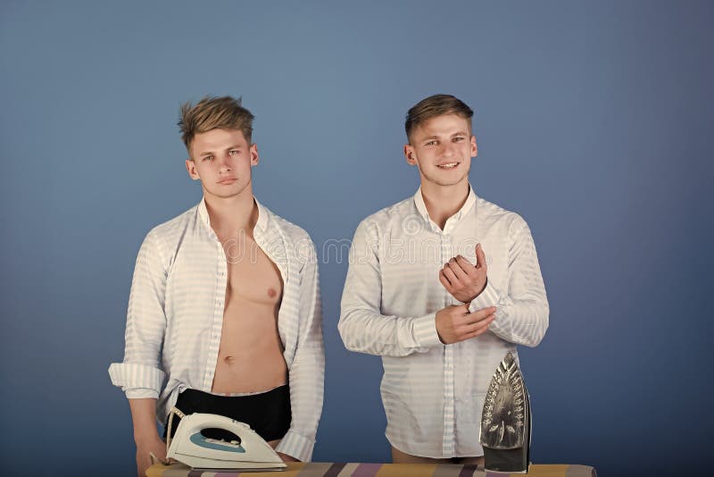 Two men getting dressed stock image. Image of muscle - 125555337
