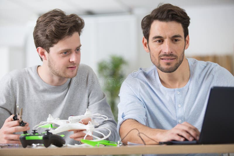 Two Men Getting Online Help To Assemble Drone Stock Image - Image of ...