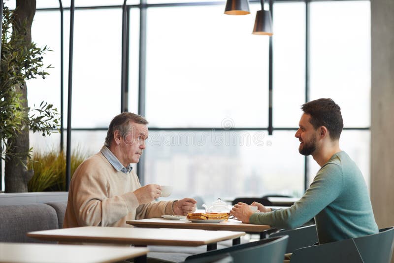 Two men having breakfast stock image. Image of coworker - 178587449
