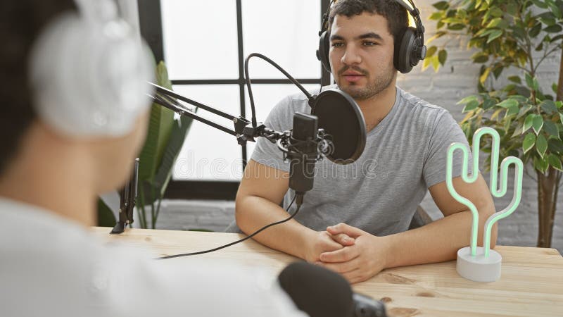 Two Men Having a Conversation in a Podcast Studio with Microphones and ...