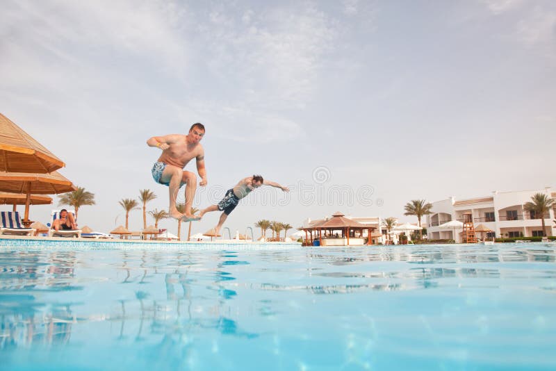 Two Men Having Fun at Swimming Pool. Stock Photo - Image of look ...