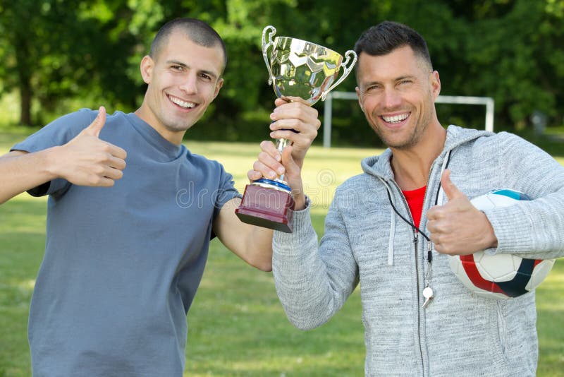 Two men holding trophy stock image. Image of metal, confident - 281820133