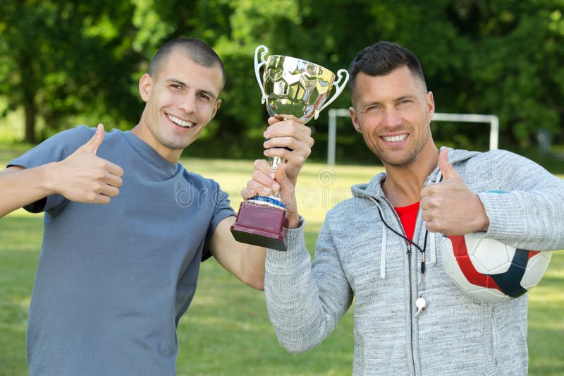 Two men holding trophy stock image. Image of metal, confident - 281820133