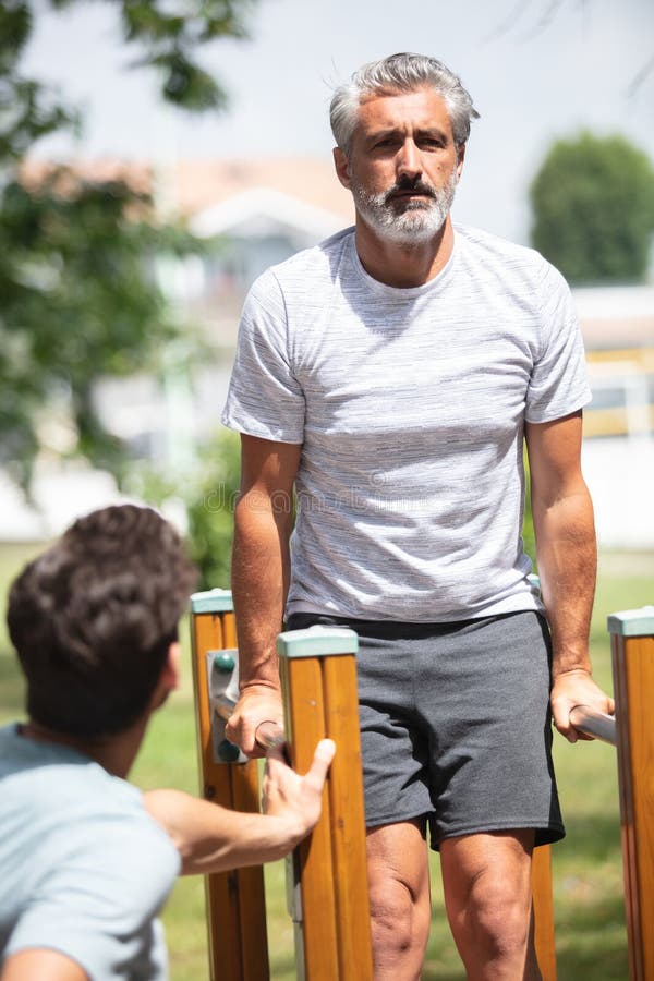 Two men on horizontal bars stock image. Image of focused - 287837373