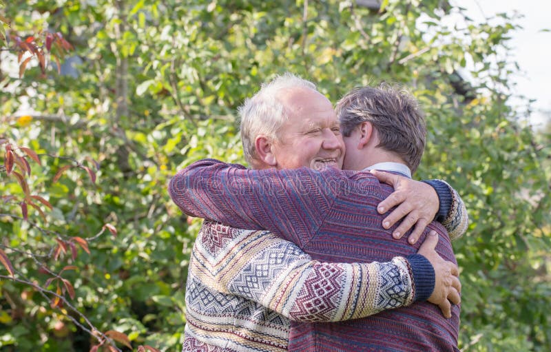 Two Men Hugging in Autumn Park Stock Photo - Image of male, family ...