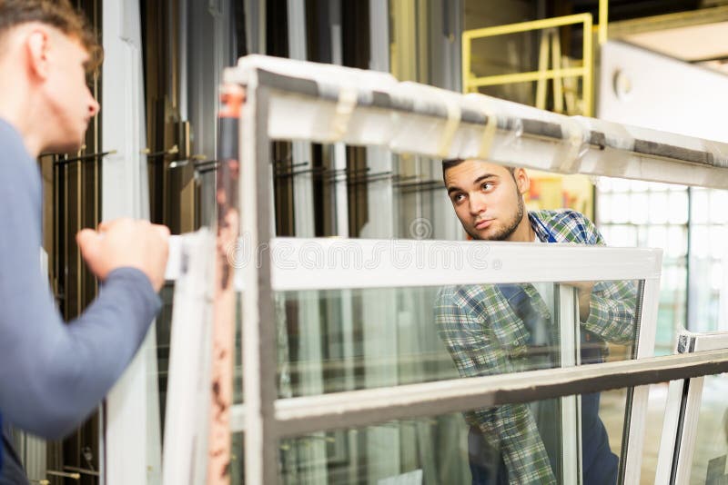 Two men inspecting windows stock image. Image of factory - 52650291