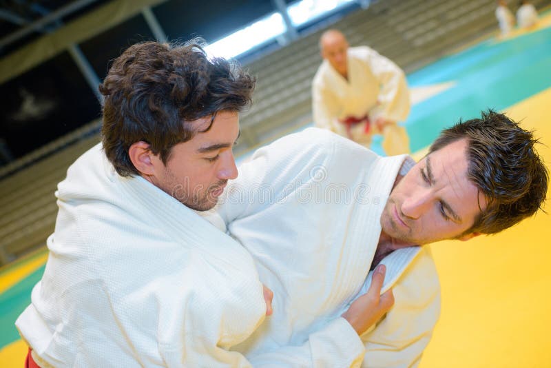 Two men in judo combat stock image. Image of agression - 282353739