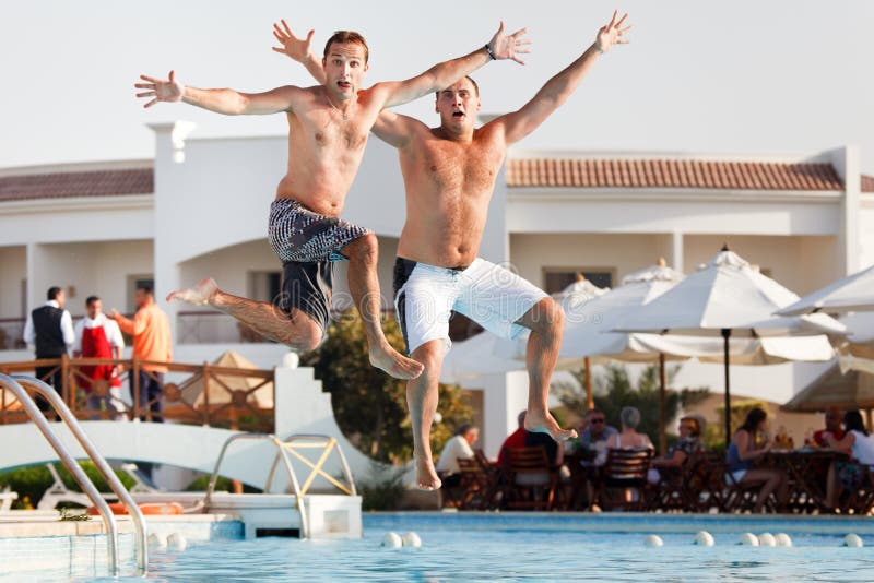 Two Men Jumping in Swimming Pool Stock Photo - Image of look, active ...