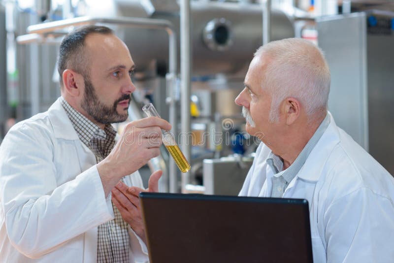 Two Men in Lab Coat with Beaker in Beer Factory Stock Photo - Image of ...