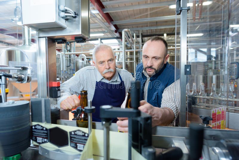 Two Men by Labelling Machine in Bottling Plant Stock Image - Image of ...