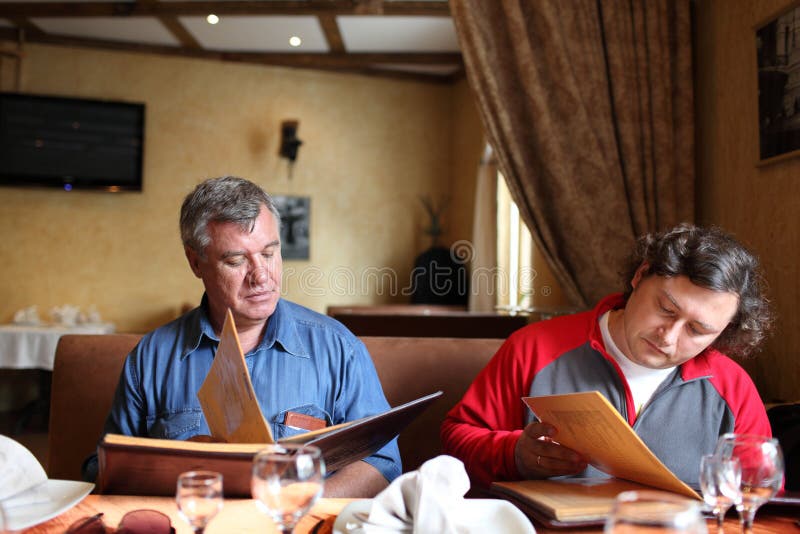 Two men look menu stock image. Image of reading, break - 20058557