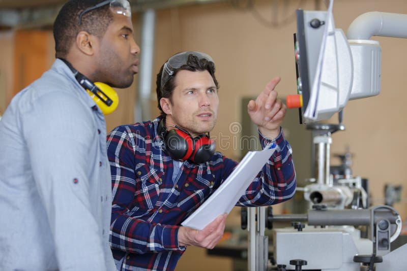 Two Men Looking at Computer Screen Stock Image - Image of floor ...
