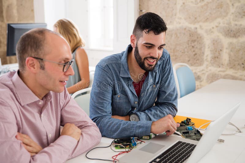 Two Men Looking at a Laptop and Smiling Stock Photo - Image of talking ...