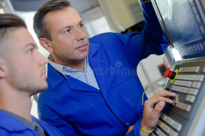 Two men looking at monitor stock photo. Image of worker - 122047404
