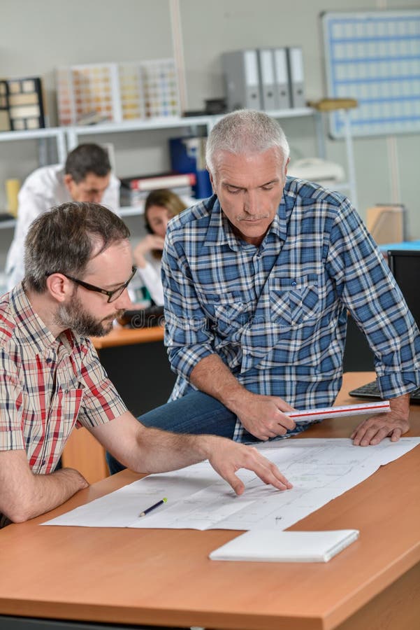 Two Men Looking Paperwork One Sat Table Stock Photos - Free & Royalty ...