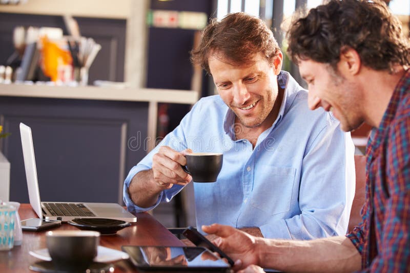 Two Men Meeting at a Coffee Shop Stock Image - Image of middle, phone ...