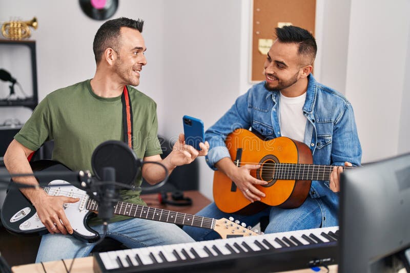 Two Men Musicians Playing Classical and Electrical Guitar Looking ...