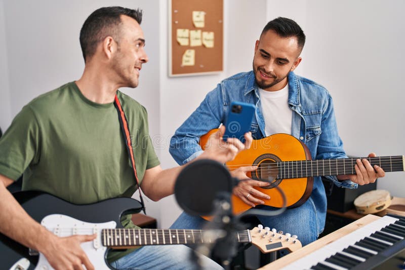 Two Men Musicians Playing Classical and Electrical Guitar Looking ...