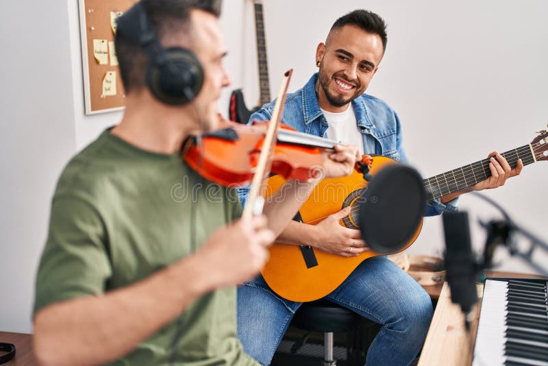 Two Men Musicians Playing Classical Guitar and Violin at Music Studio ...