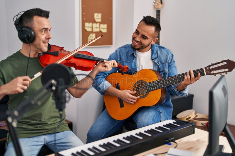 Two Men Musicians Playing Classical Guitar and Violin at Music Studio ...
