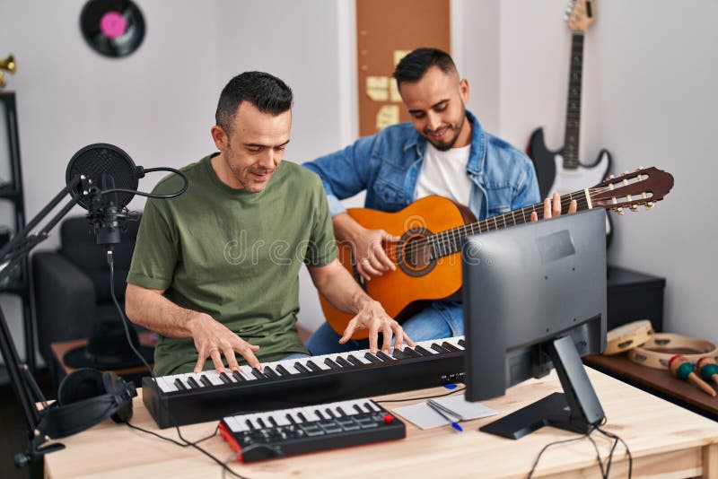 Two Men Musicians Playing Piano and Classical Guitar at Music Studio ...