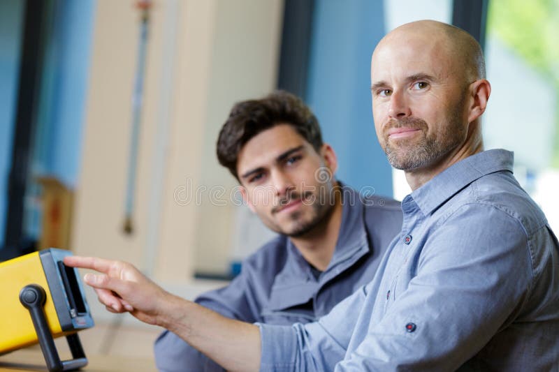 Two men operating machine stock photo. Image of panel - 285319610