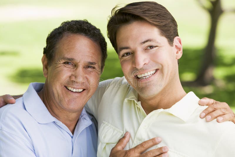 Two Men Outdoors Embracing and Smiling Stock Photo - Image of aged ...