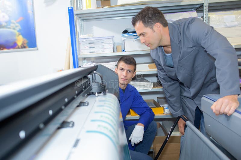 Two Men Overseeing Printing Machine Stock Photo - Image of company ...