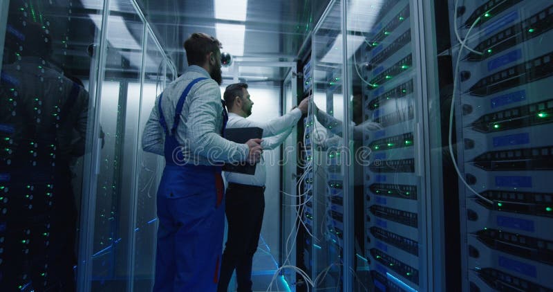 Two Men Performing Maintenance in a Data Center Stock Image - Image of ...