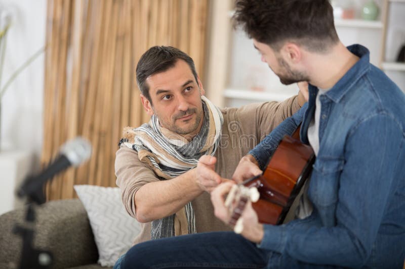 Two Men Playing Acoustic Guitar Stock Image - Image of lovers ...