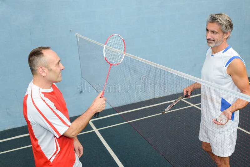 Two men playing badminton stock photo. Image of badminton - 283607032