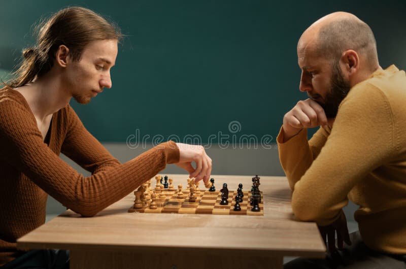 Two Men Playing Chess at Home Sitting at the Table. Concept of Hobby ...
