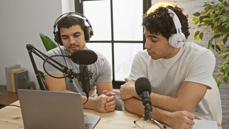 Two Men Podcasting with Microphone and Laptop in a Modern Studio ...