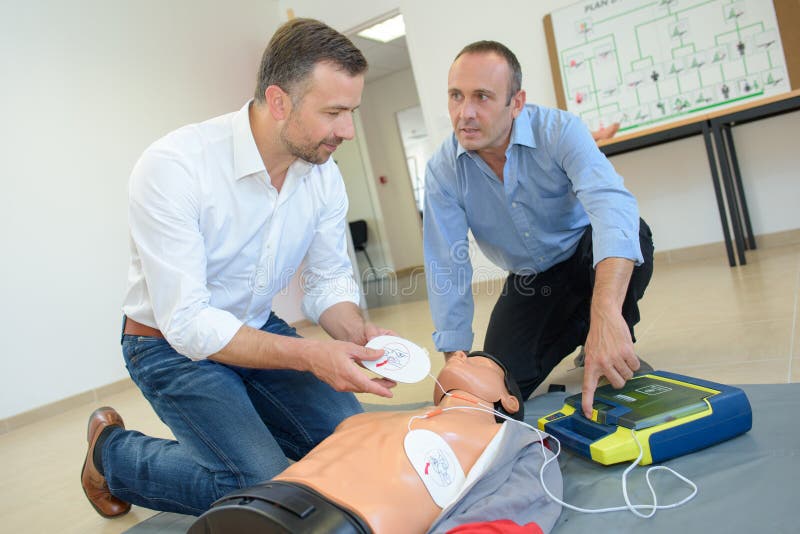 Two Men Practicing First Aid Stock Image - Image of board, profession ...