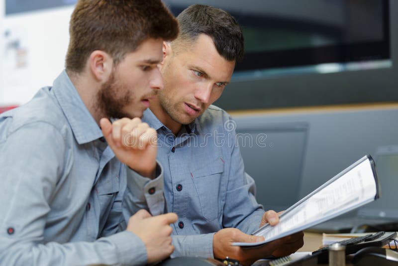 Two Men Reading and Discussing Papers Stock Photo - Image of analyst ...