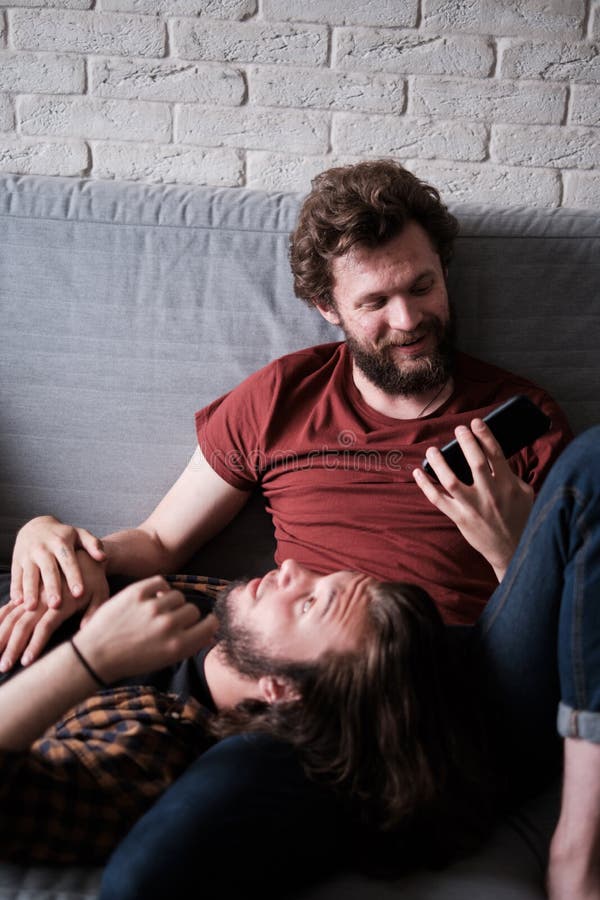 Two Men Relaxing Together on the Sofa Stock Image - Image of boyfriend ...