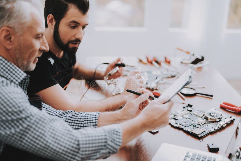 Two Men Repairing Hardware Equipment in Workshop. Stock Photo - Image ...
