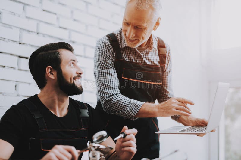 Two Men Repairing Hardware Equipment in Workshop Stock Image - Image of ...
