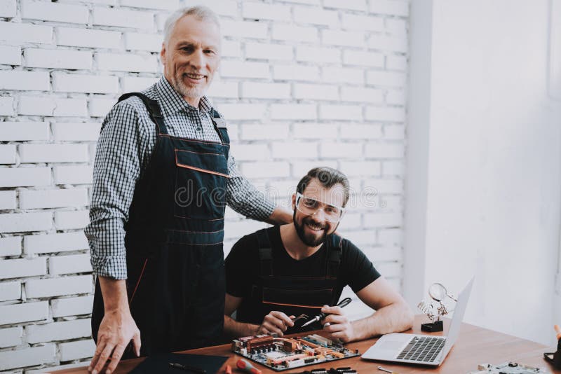 Two Men Repairing Hardware Equipment in Workshop. Stock Photo - Image ...