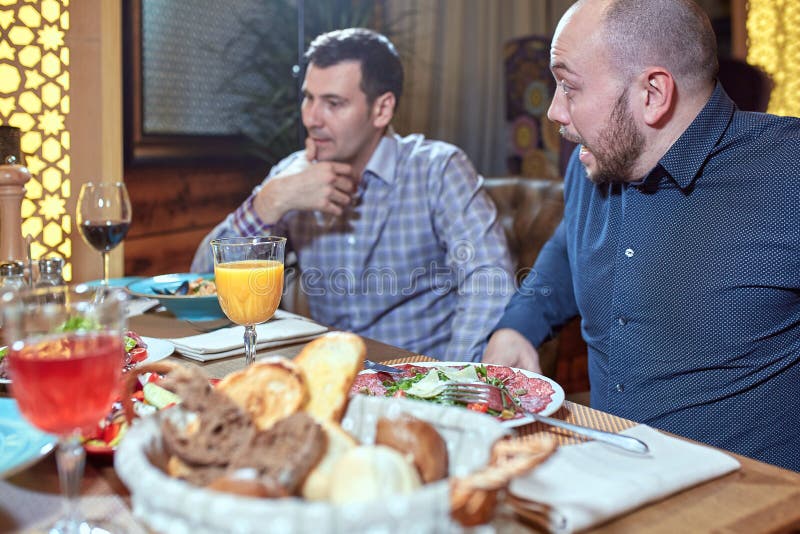 Two Men in a Restaurant Arguing during Lunch Stock Photo - Image of ...