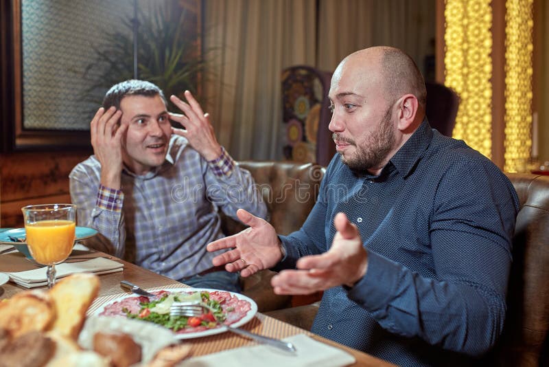 Two Men in a Restaurant Arguing during Lunch Stock Image - Image of ...