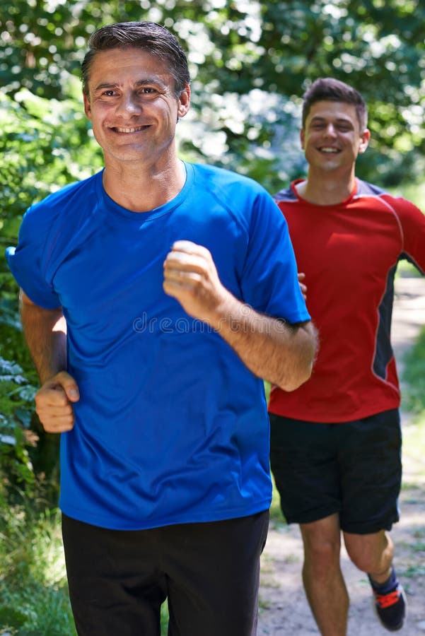 Two Men Running in Countryside Together Stock Image - Image of happy ...