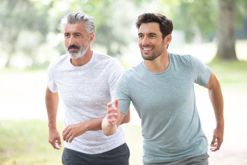 Two men running outdoors stock image. Image of games - 289629125