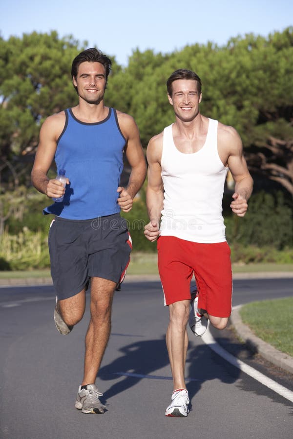 Two Men Running on Road stock image. Image of exercising - 54939055