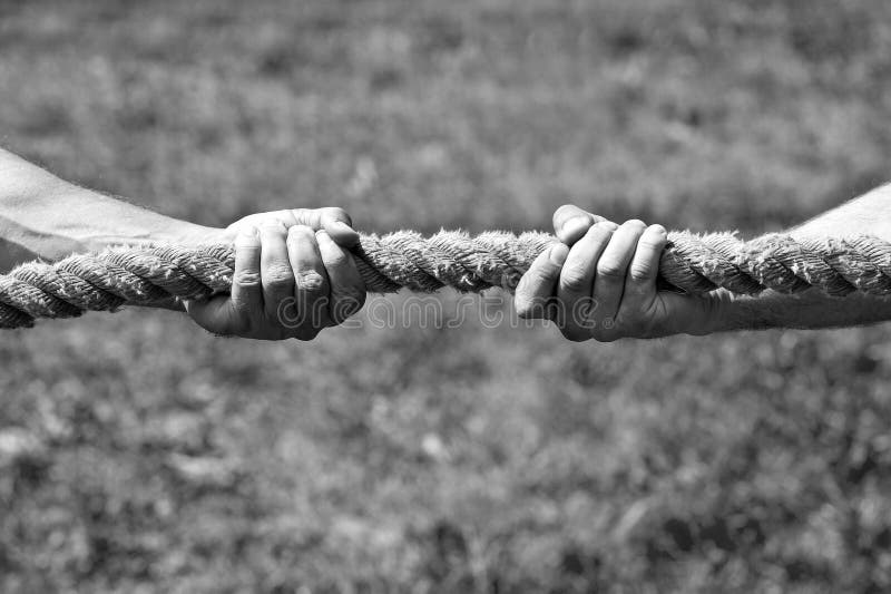 Two Men`s Hands Pull the Rope Each in His Own Direction. the Concept of ...
