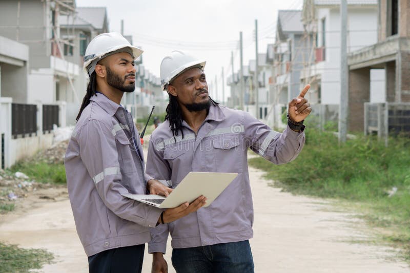Two Men in Safety Helmet Review Plan and Communicate about Construction ...