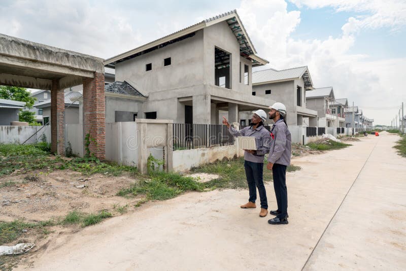 Two Men in Safety Helmet Review Plan and Communicate about Construction ...