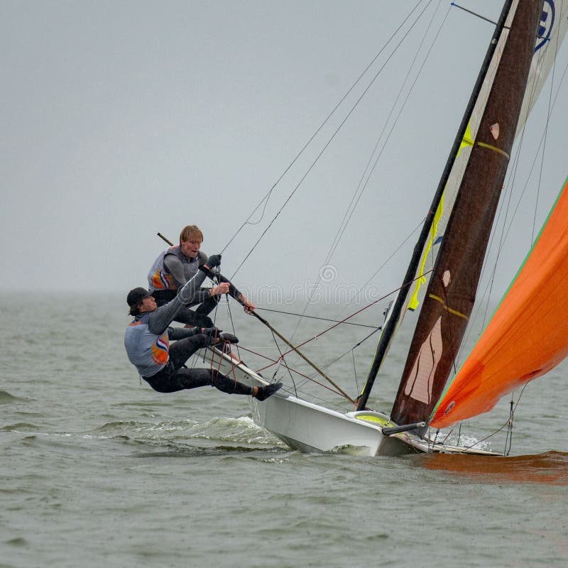 Two Men in a Sailboat Navigating Choppy Waters. Editorial Stock Photo ... Two Men in a Sailboat Navigating Choppy Waters. Editorial Stock Photo ...